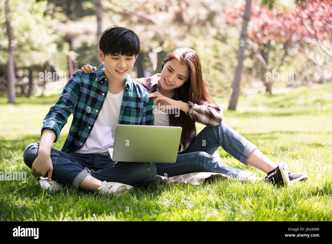 Young asian couple using laptop hi-res stock photography and images - Alamy