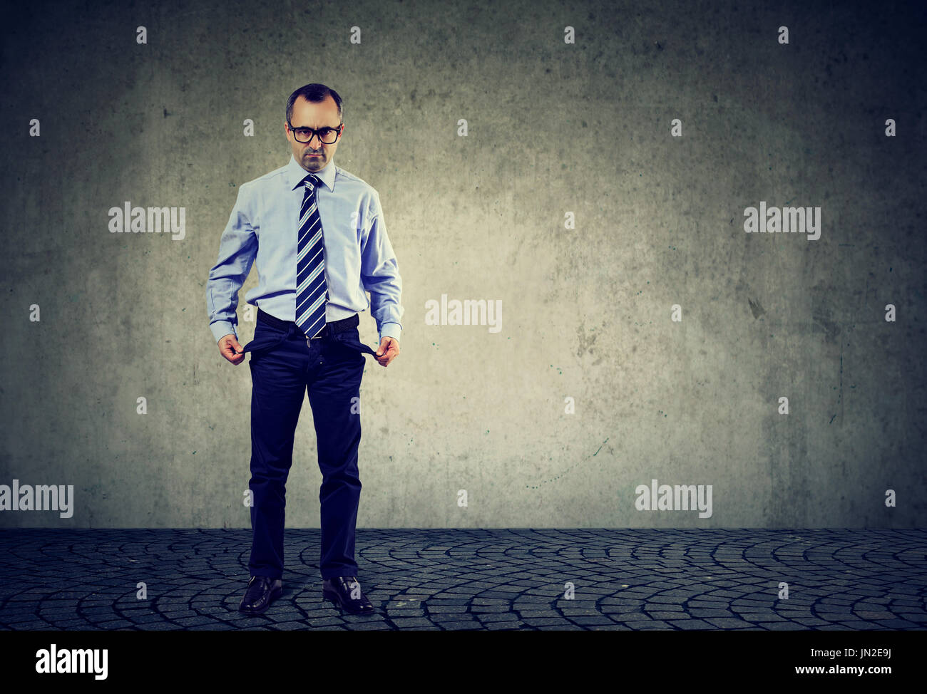 Sad business man with empty pockets Stock Photo - Alamy