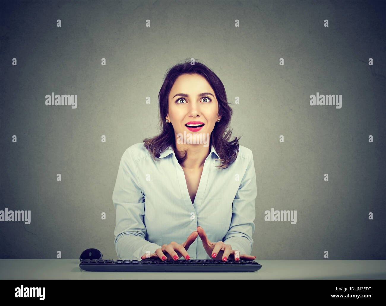Smiling surprised woman using a computer Stock Photo - Alamy