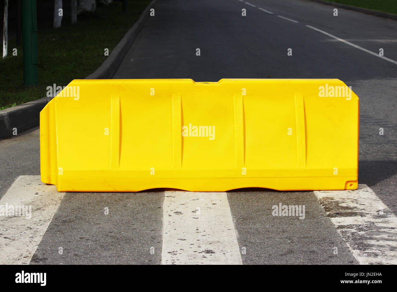 One yellow plastic barrier is blocking the road Stock Photo - Alamy