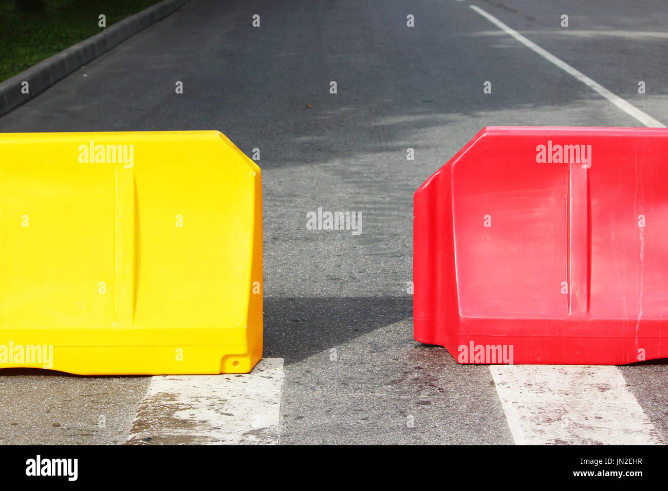 Red and yellow plastic barriers blocking the road Stock Photo - Alamy