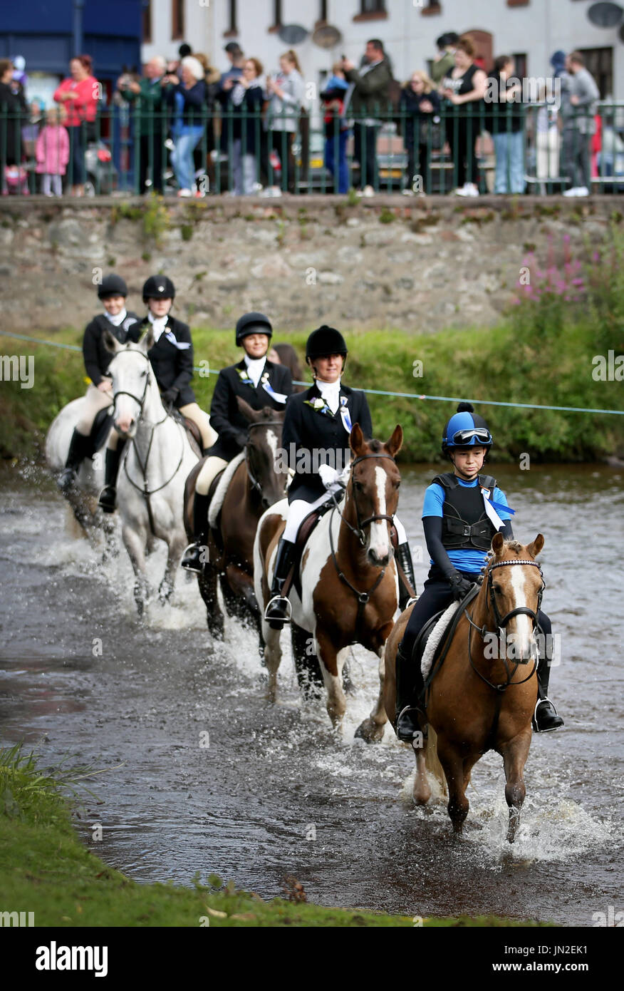Horse and riders take part in the Riding of the Marches ford on the ...