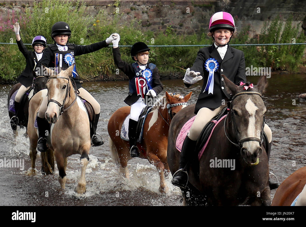 Horse and riders take part in the Riding of the Marches ford on the ...