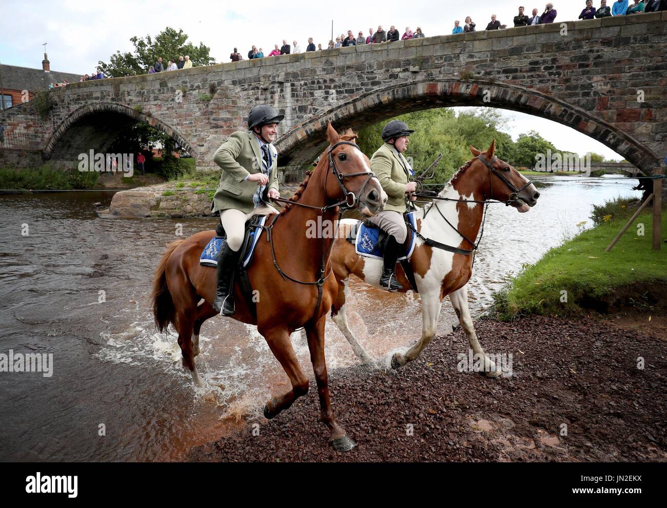 Horse and riders take part in the Riding of the Marches ford on the ...