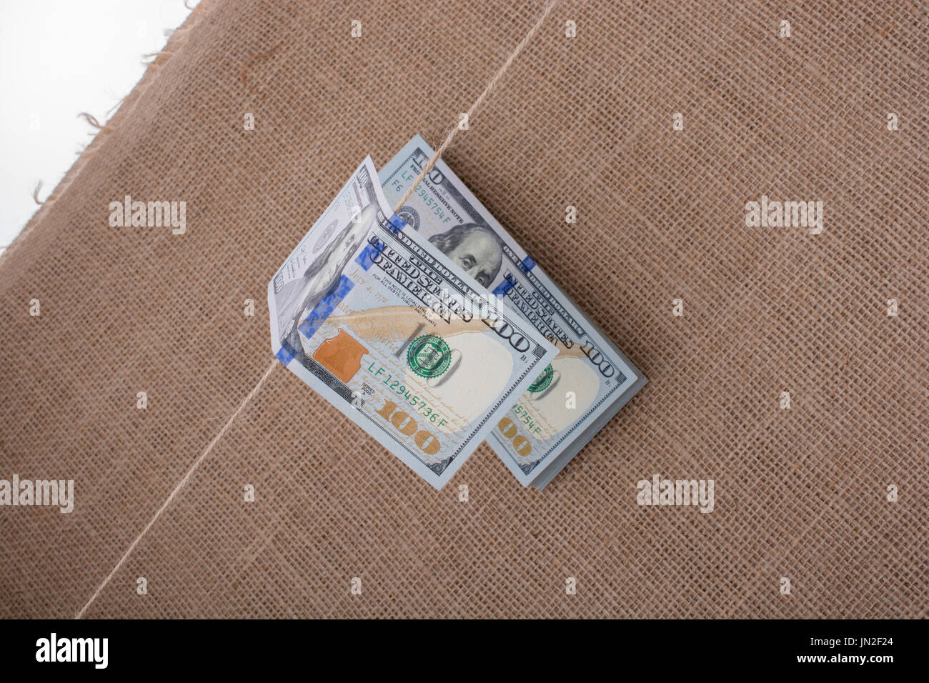 Banknote of US dollar hanging on a linen string Stock Photo - Alamy