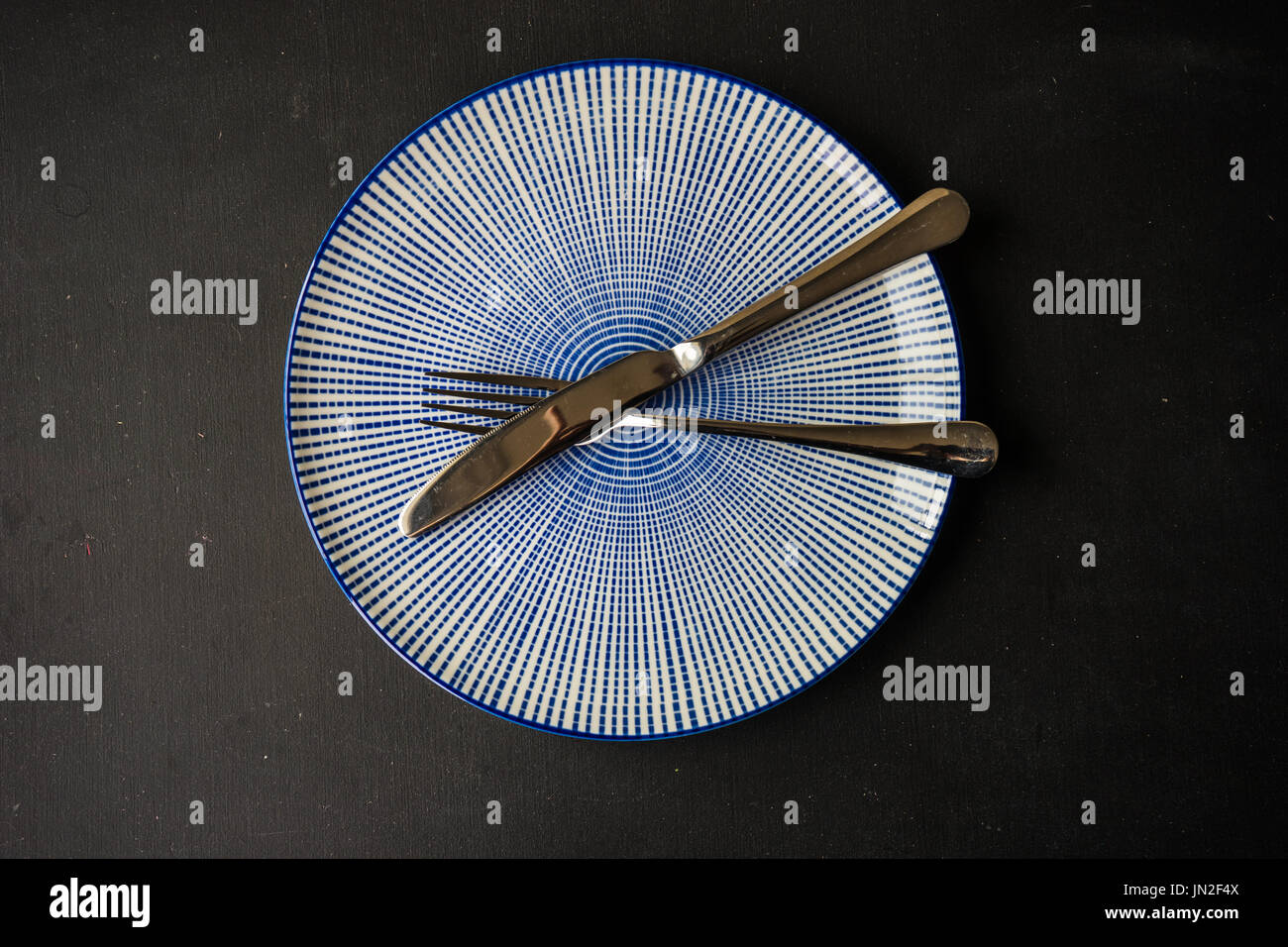 Rustic table setting - vintage silverware and blue stripped plate on ...