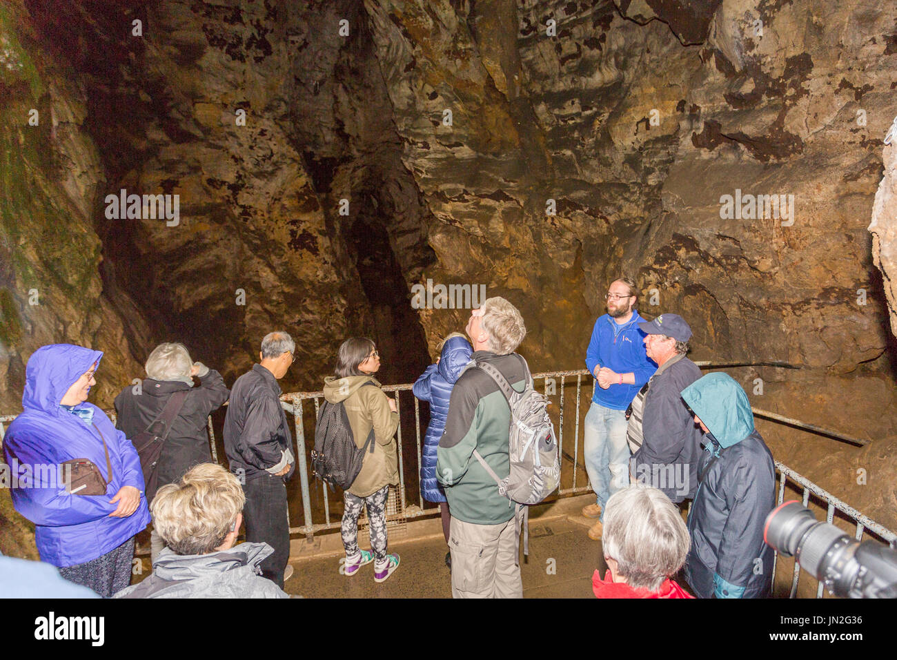 A group of tourists and guide and the deepest point in the Blue John ...