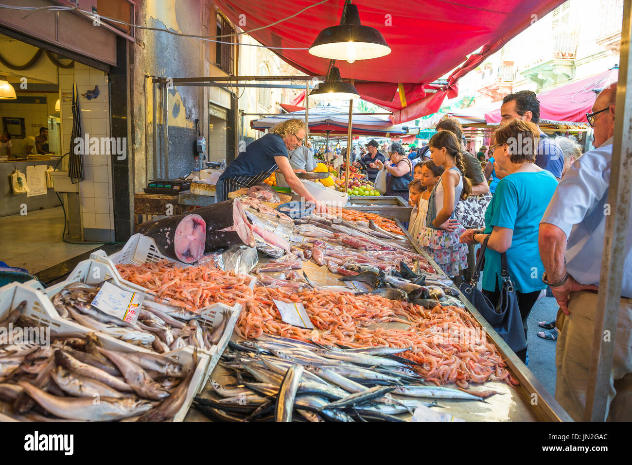 Fish market Italy, customers queue to buy freshly caught seafood in the ...