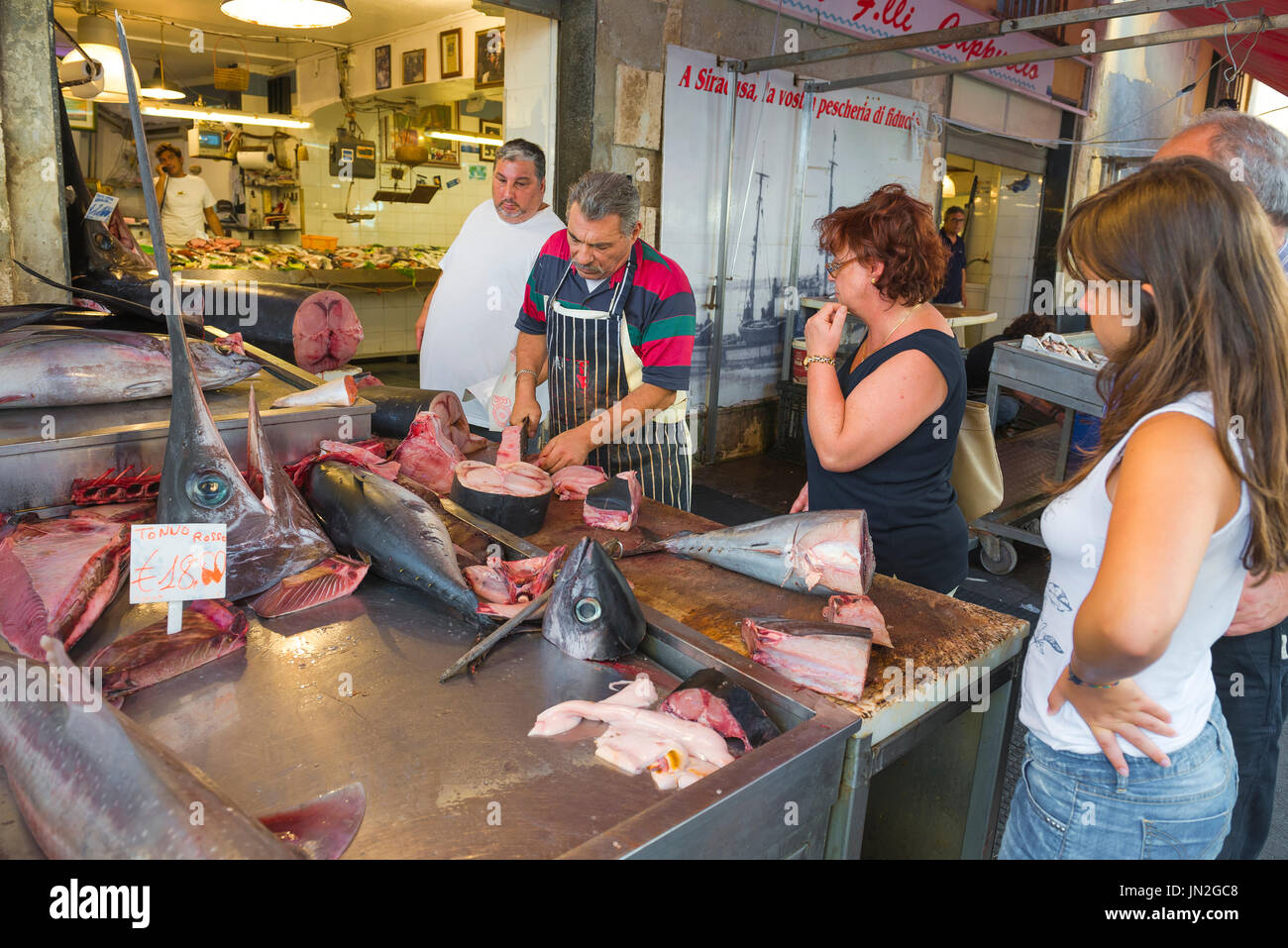 Sicily fish market, view of people queuing to buy fresh tuna steaks in ...
