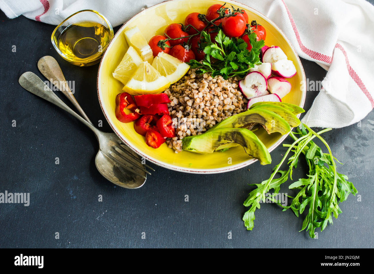 Healthy food concept - rustic ceramic bowl with organic avocado, radish ...