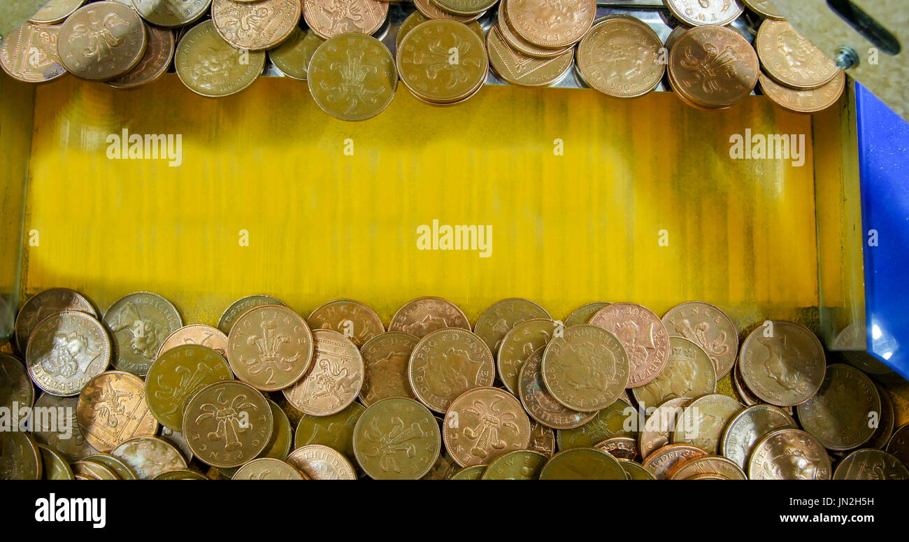 Old fashioned arcade money coin pushing machine Stock Photo - Alamy