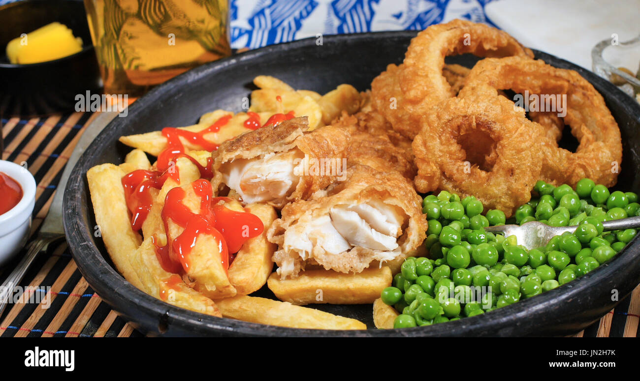 English fish and chips with garden peas, ring onions and mushy peas ...