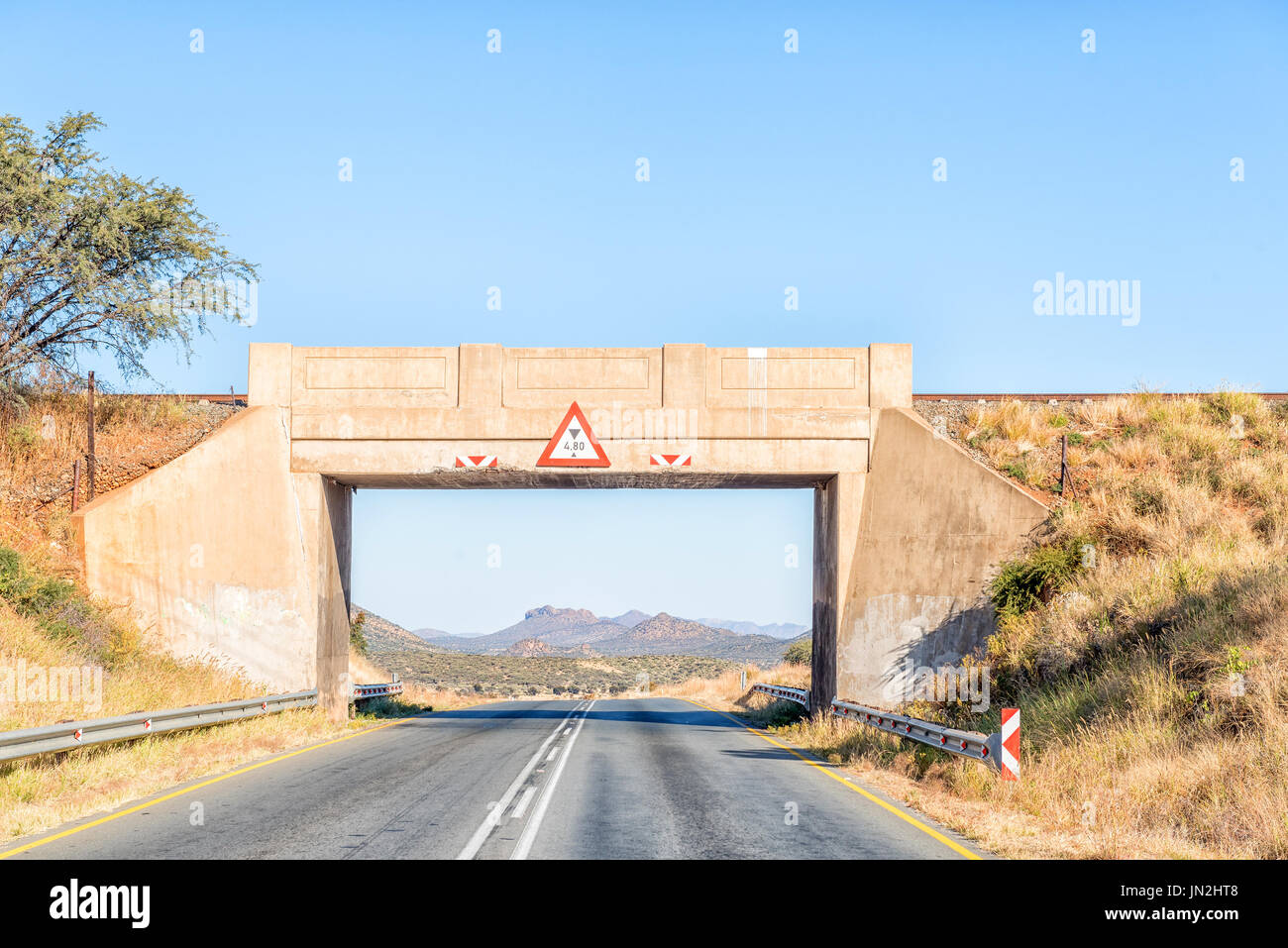 A railway bridge over the B1-road frames a mountain scene south of ...