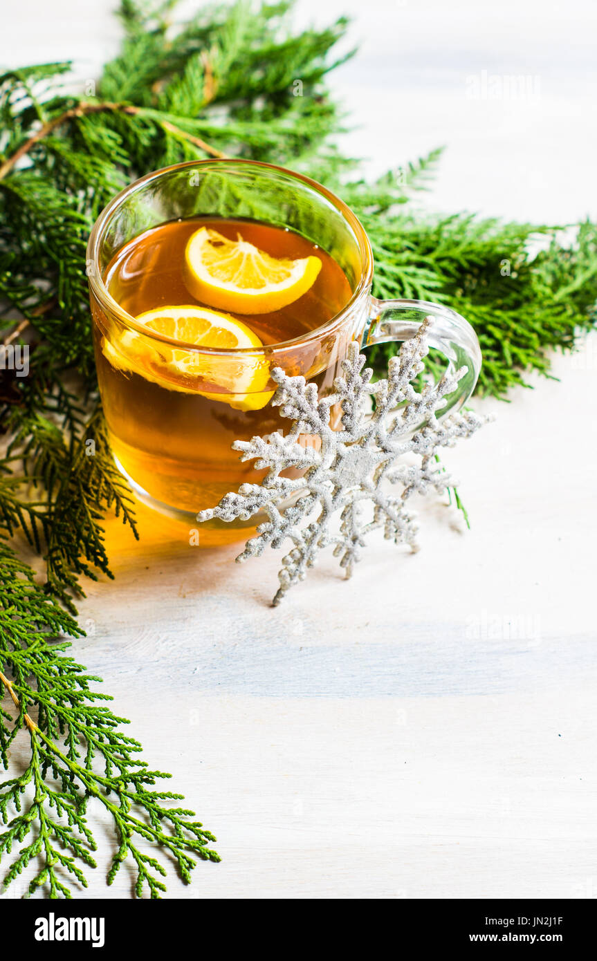 Cup of Tea with a Lemon and Cinnamon on Christmas background with snow ...