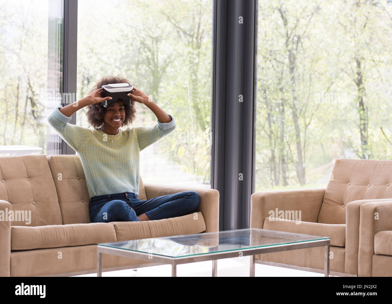 Happy african american girl getting experience using VR headset glasses ...