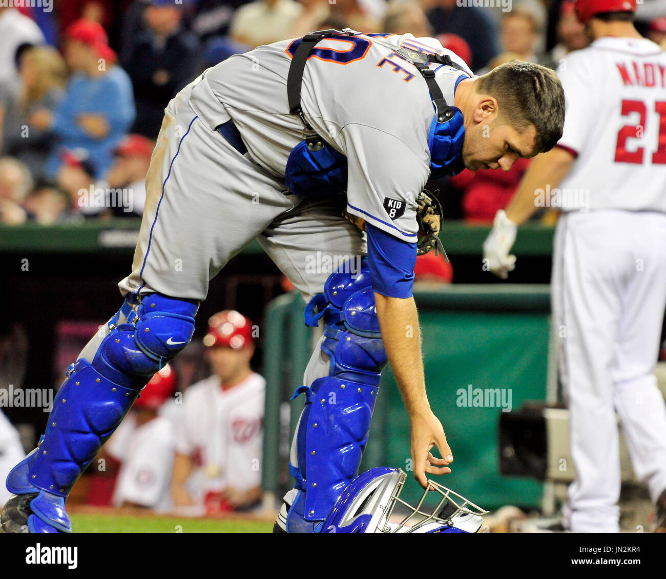 New York Mets catcher Josh Thole (30) recovers his mask after chasing a ...