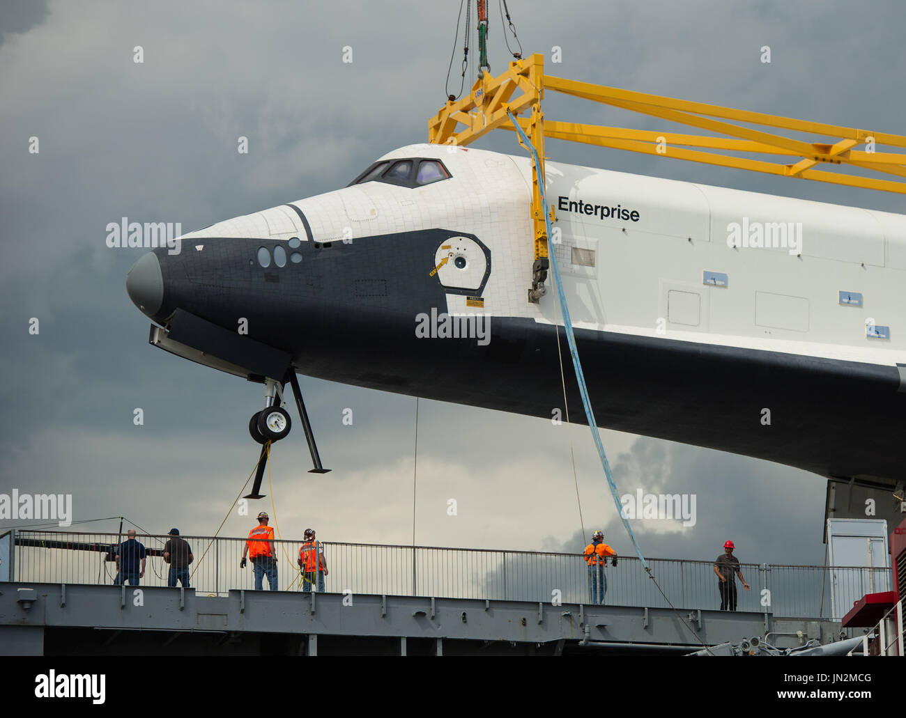 The space shuttle Enterprise is lifted off of a barge and onto the ...