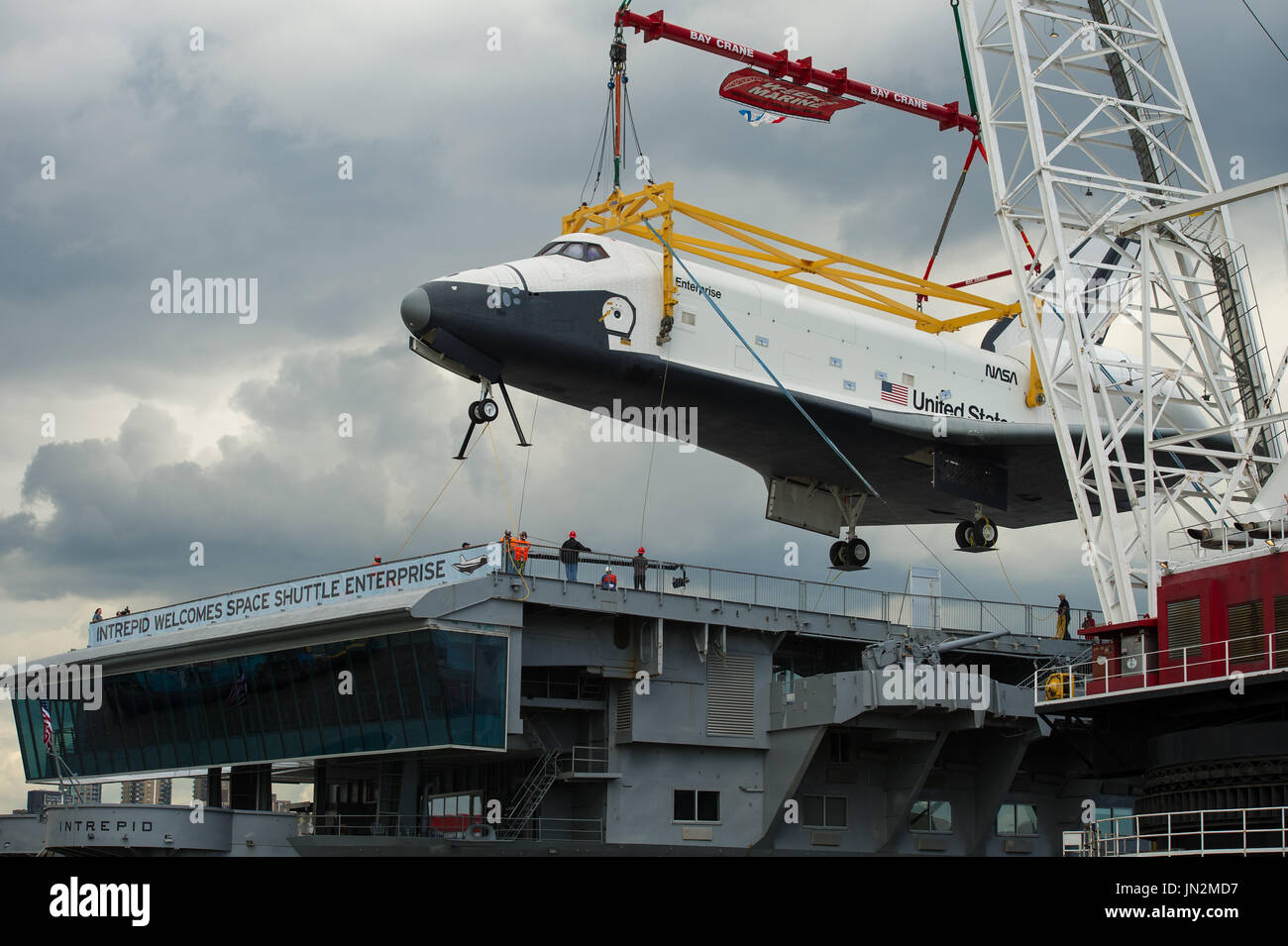 The space shuttle Enterprise is lifted off of a barge and onto the ...