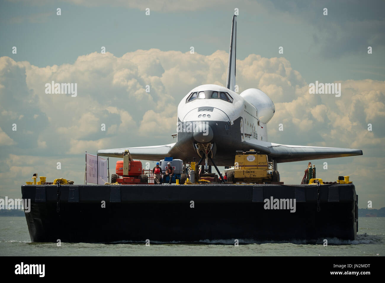 The space shuttle Enterprise is towed by barge up the Hudson River on ...