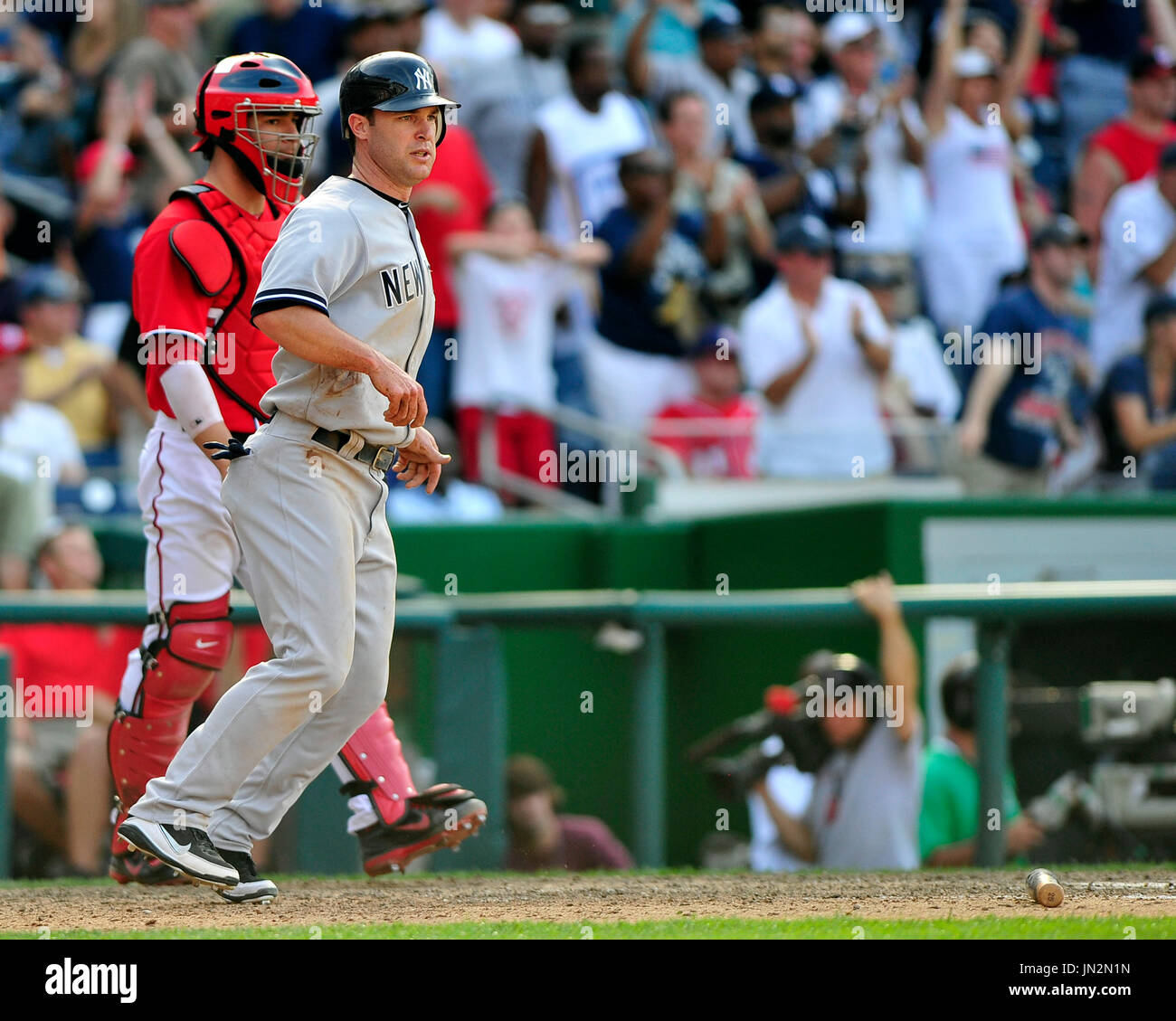 New York Yankees Jayson Nix looks back at the action after scoring on a ...