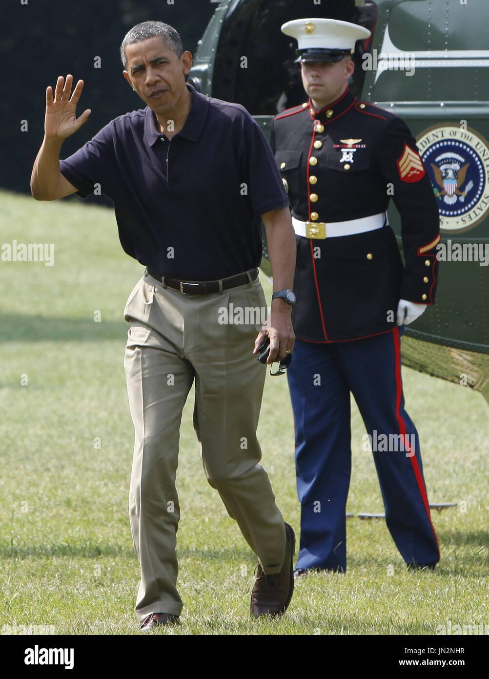 United States President Barack Obama waves as he walks on the South ...