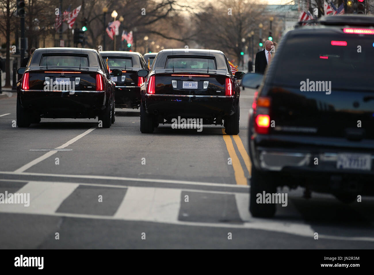 Limousines drive in the presidential inaugural parade through the ...