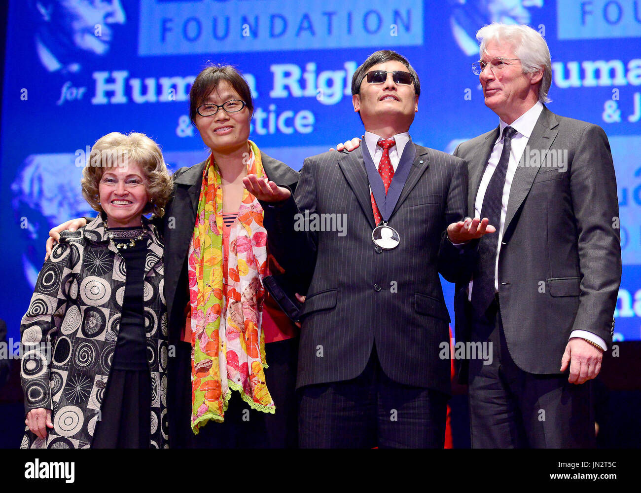 Chen Guangcheng, the blind Chinese legal activist, right center, poses ...