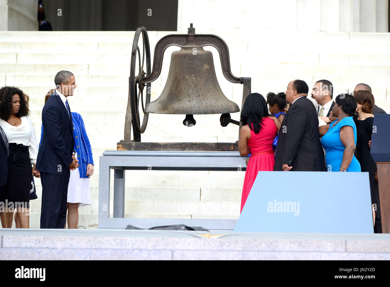 United States President Barack Obama looks on as a bell is rung at the ...
