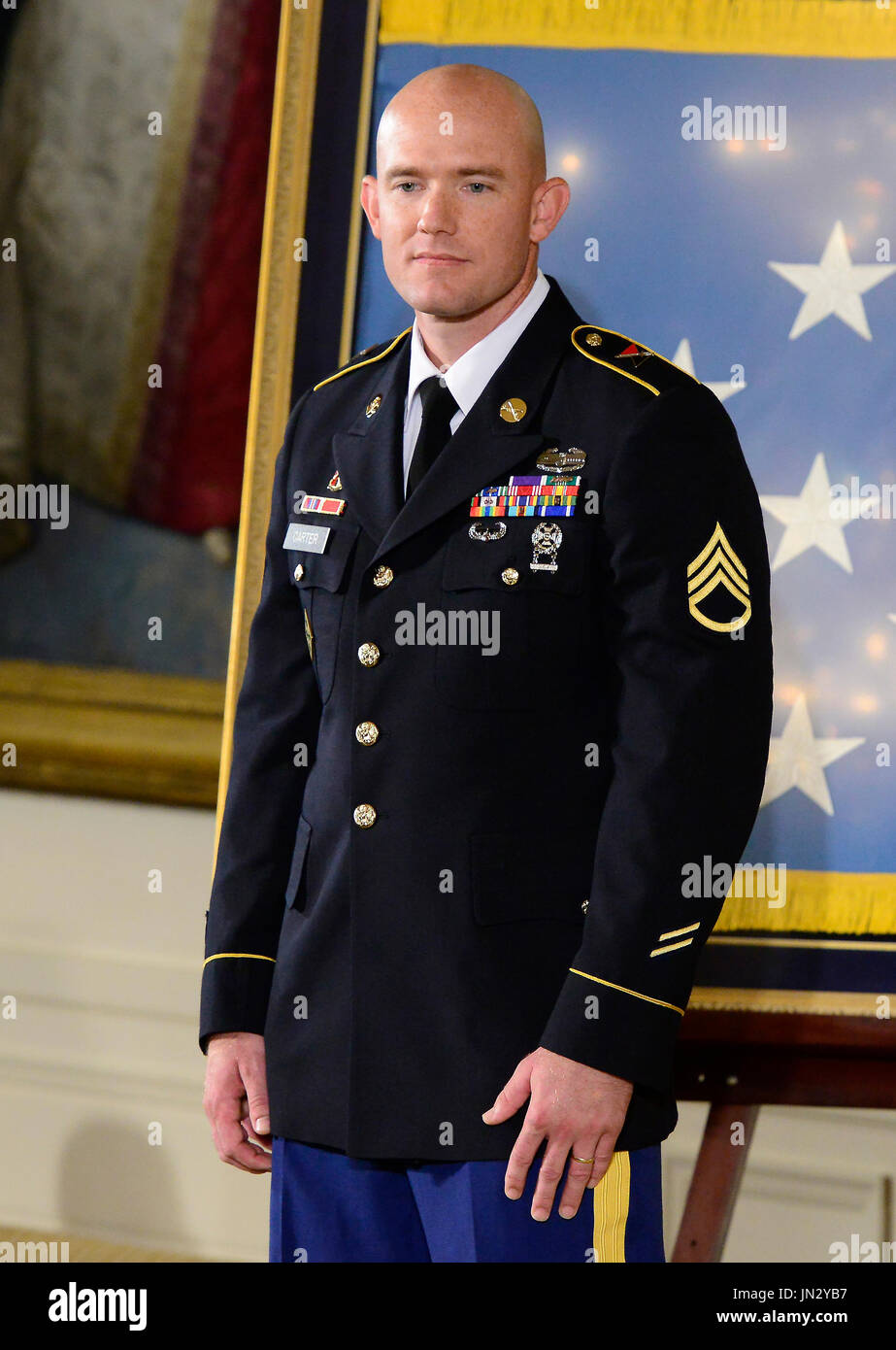 Staff Sergeant Ty M. Carter, U.S. Army, listens as United States ...