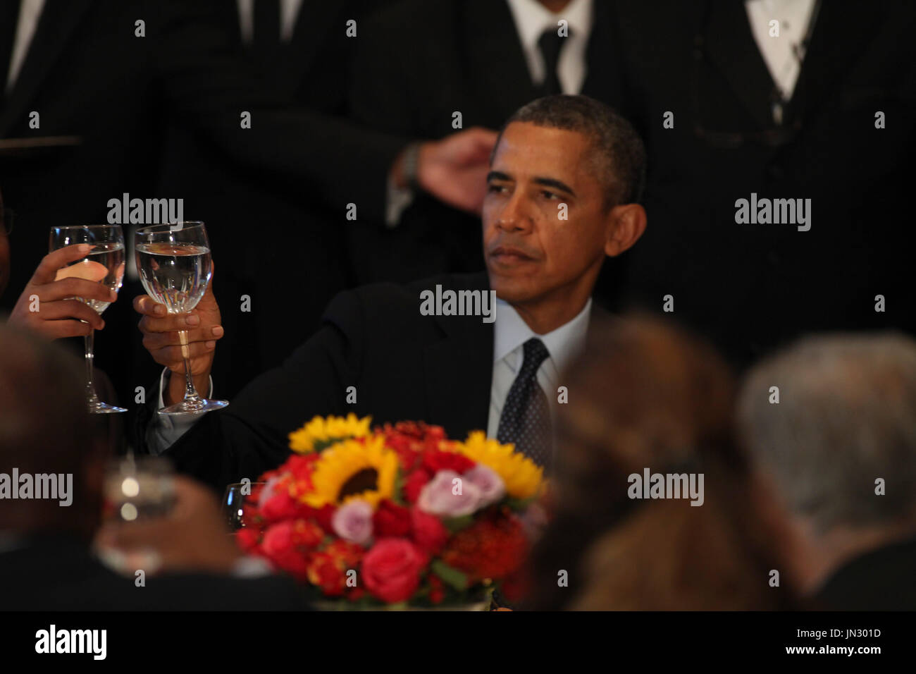 United States President Barack Obama raises his glass for a toast as he ...