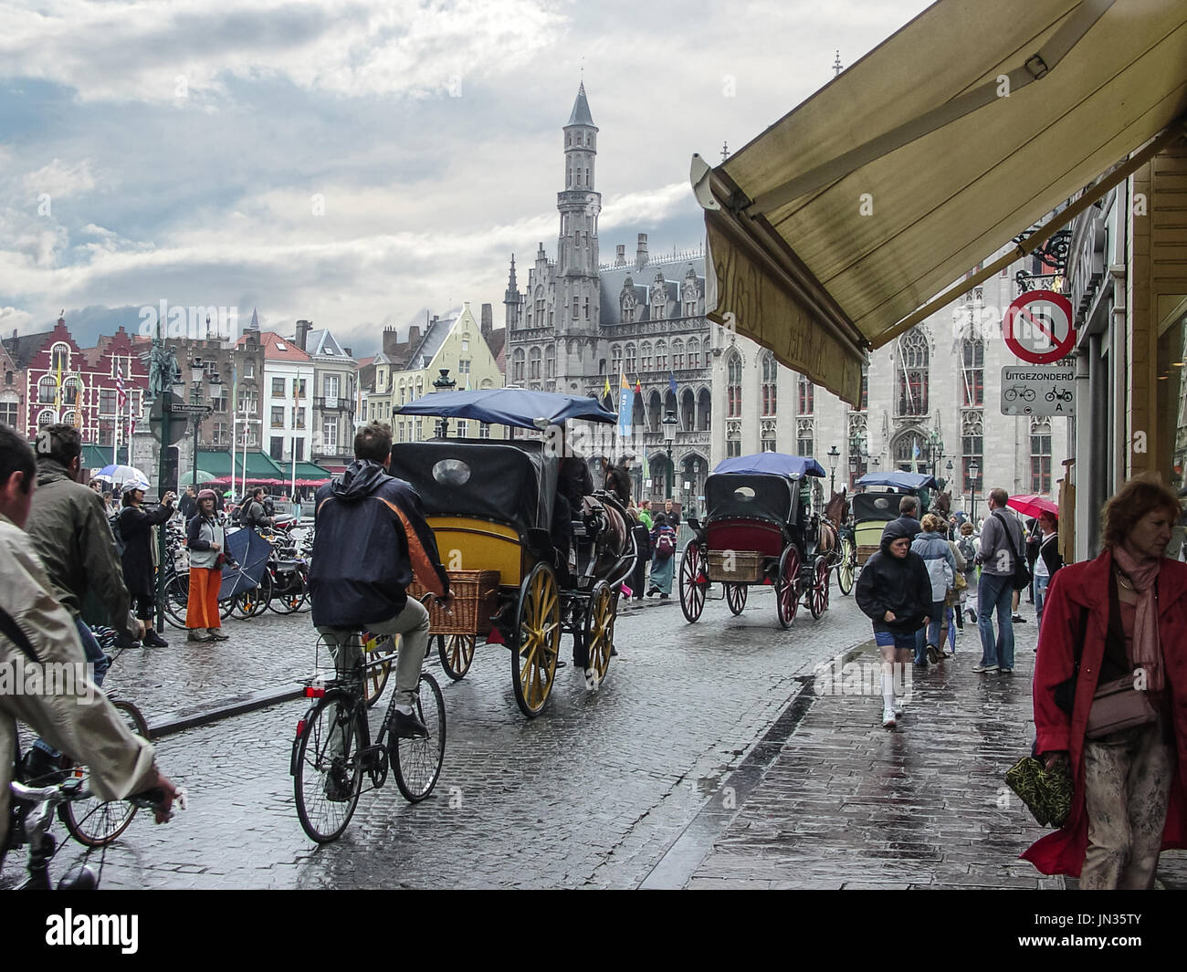 Town square in Bruges Belgium on a rainy day with lots of people out ...