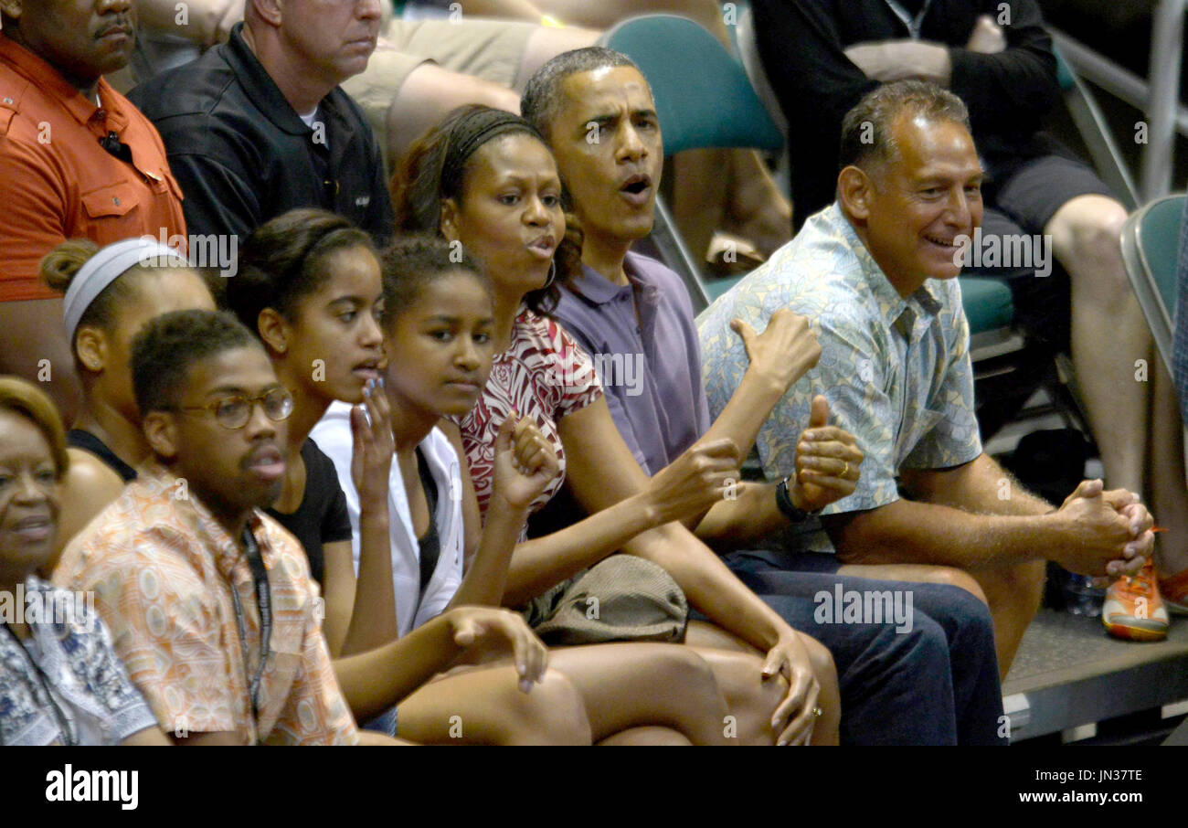 President Barack Obama reacts to a play as he, first lady Michelle ...