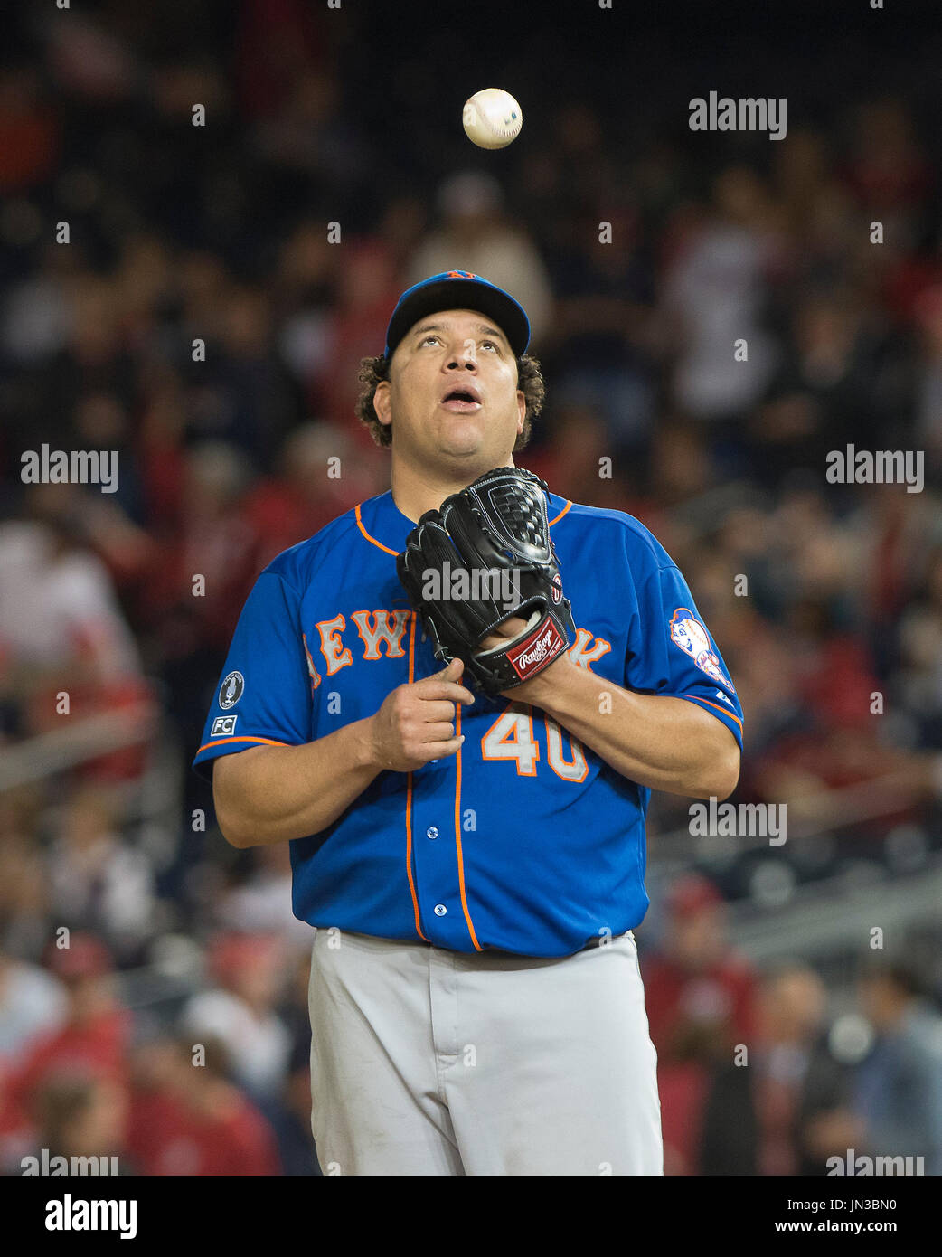 New York Mets pitcher Bartolo Colon (40) tosses the ball into the air ...