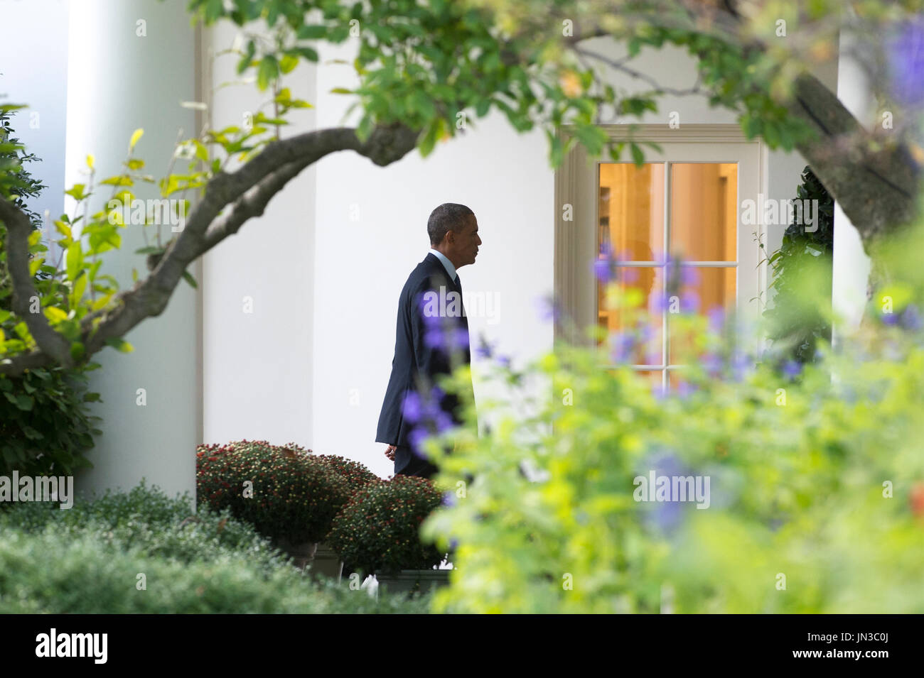 US President Barack Obama walks outside the Oval Office after arriving ...