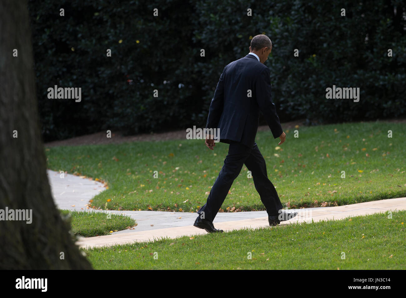 US President Barack Obama walks outside the Oval Office after arriving ...
