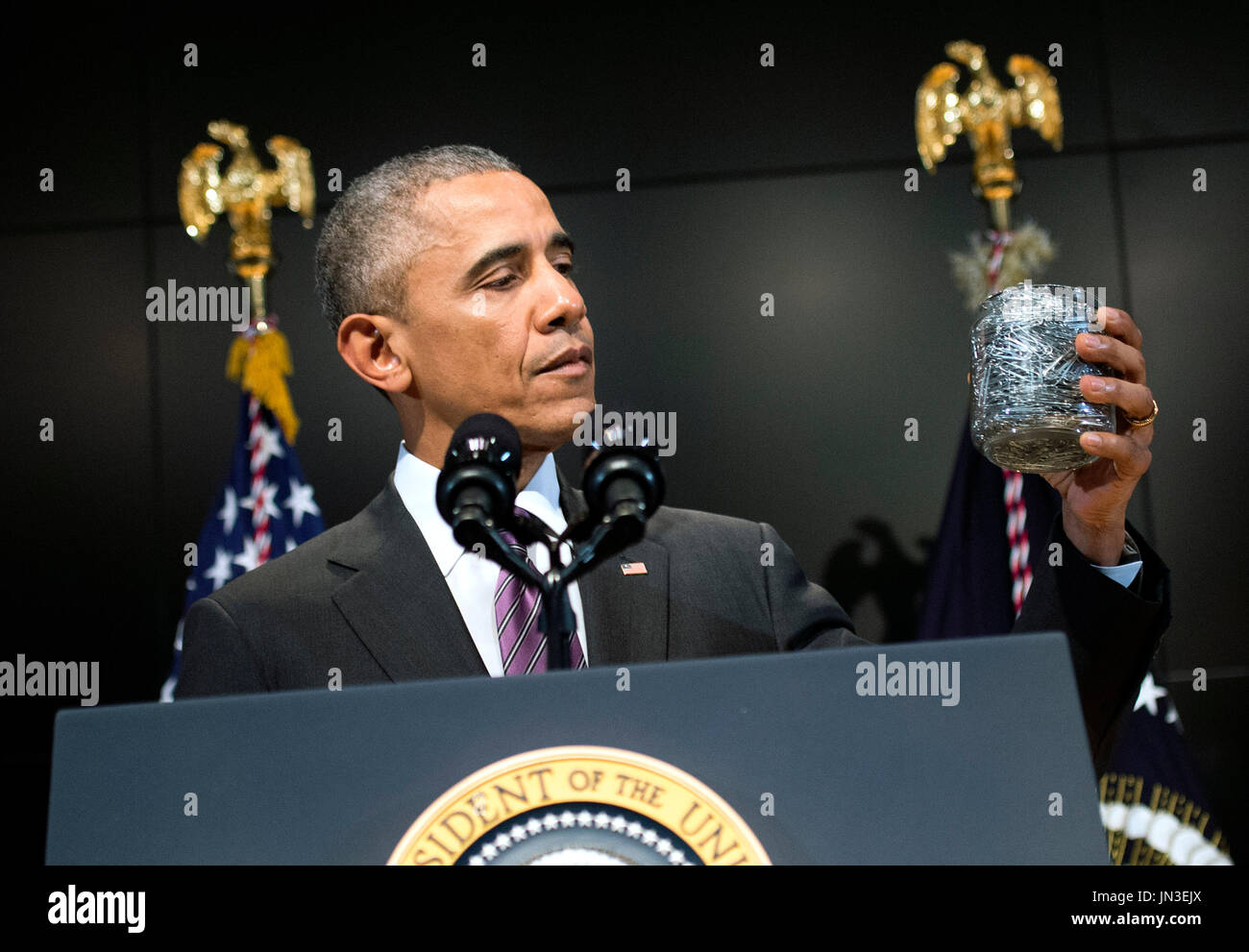United States President Barack Obama holds up a jar of paper chips as ...