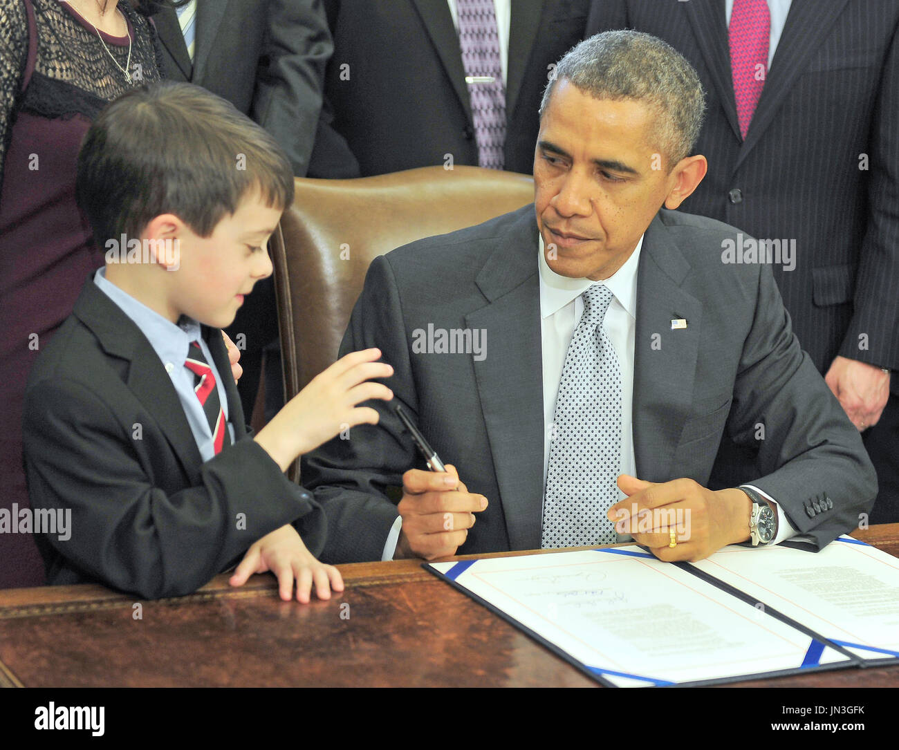 United States President Barack Obama presents a pen to Jacob Miller ...