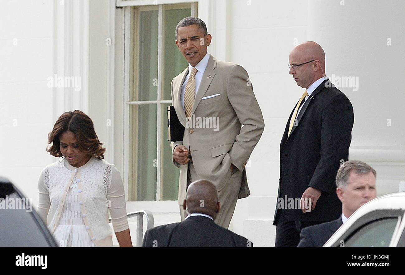 United States President Barack Obama leaves the White House with his ...