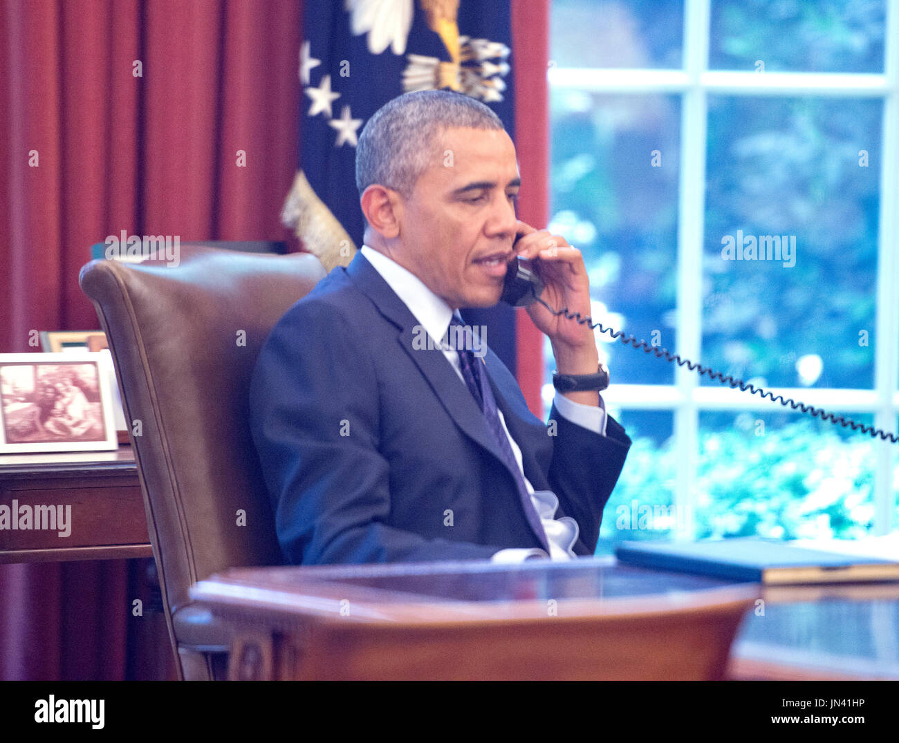 As seen through an outside window looking into the Oval Office, United ...