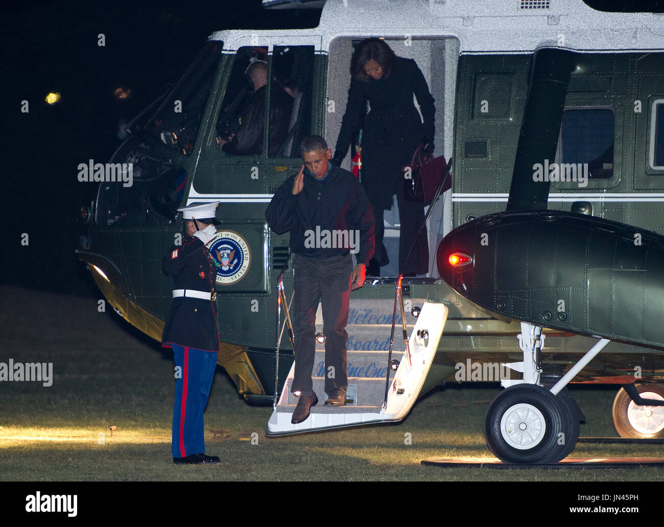 United States President Barack Obama salutes the Marine guard as he and ...