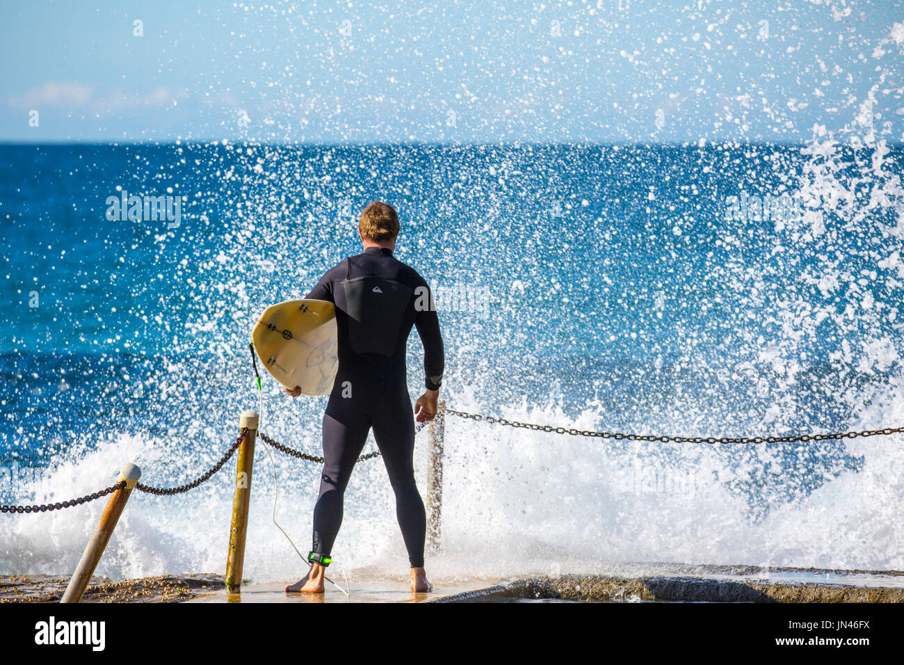 Man in wetsuit carrying surfboard hi-res stock photography and images ...