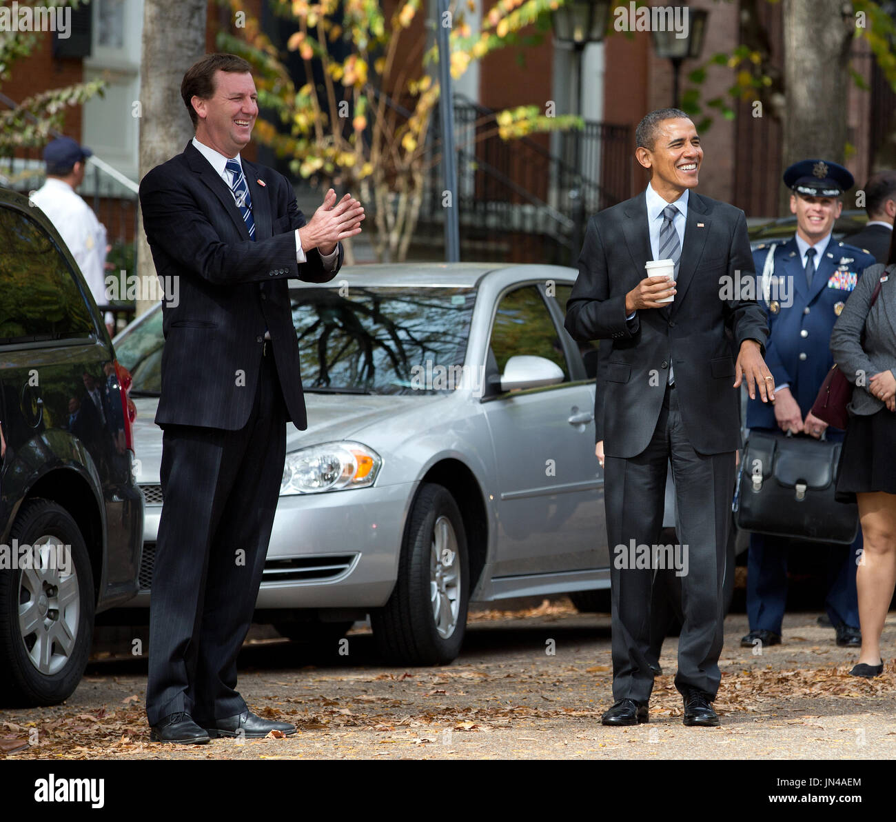 United States President Barack Obama jokes with reporters during a walk ...