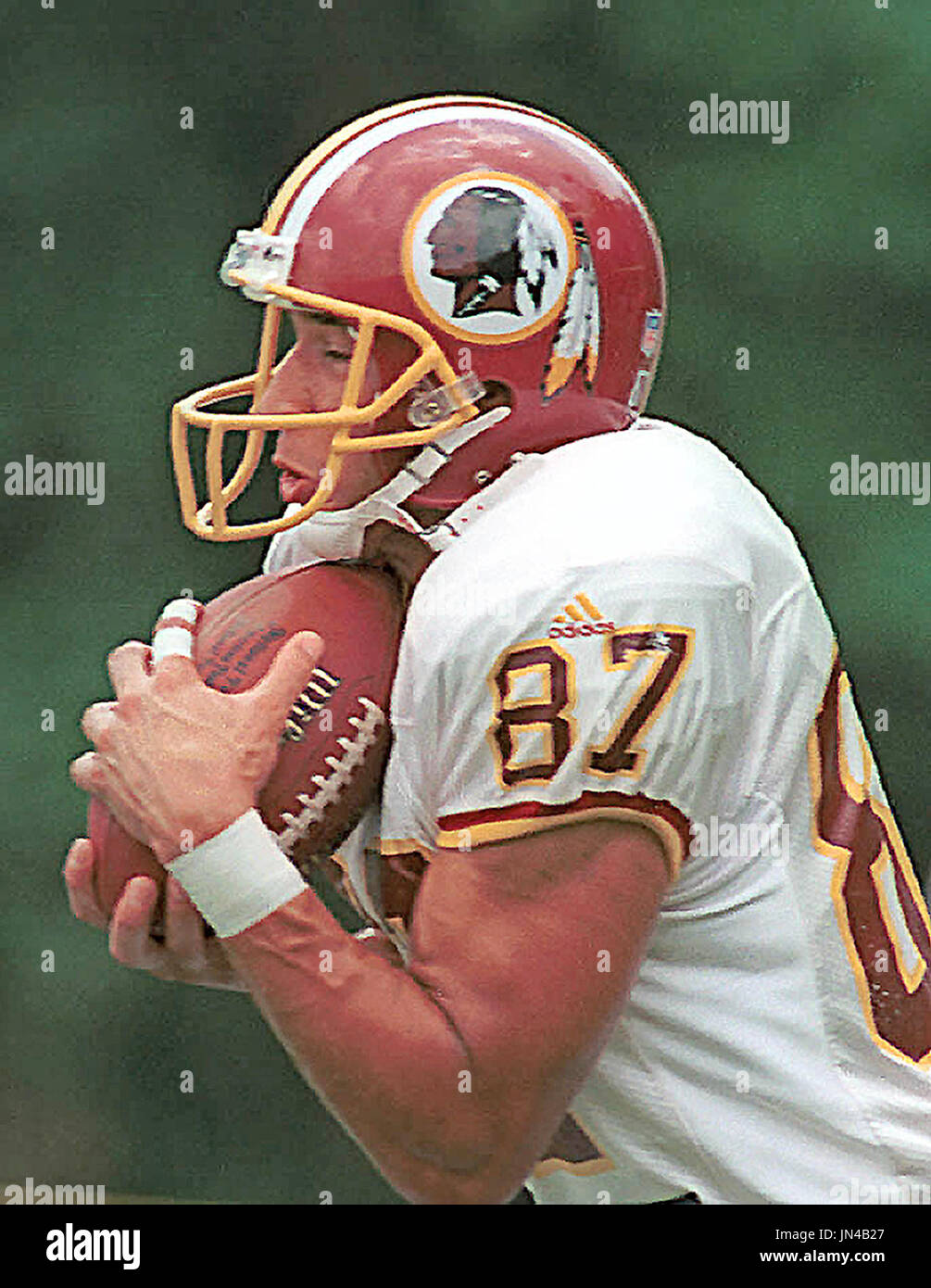 Washington Redskin wide receiver James Thrash hugs the football as he ...