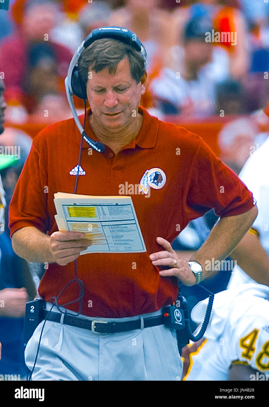 Washington Redskins head coach Norv Turner looks over his list of plays ...