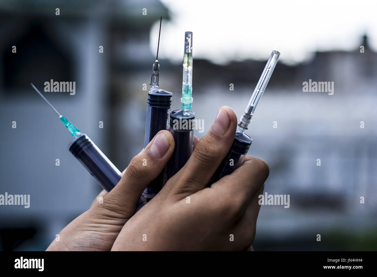 Syringe, medical injection, bottle, ampule in hand, palm or fingers ...
