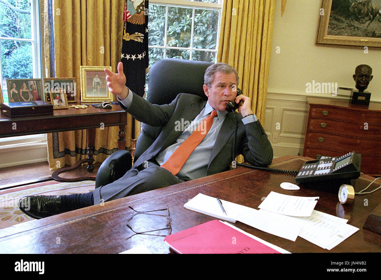 United States President George W. Bush receives a report on the phone ...