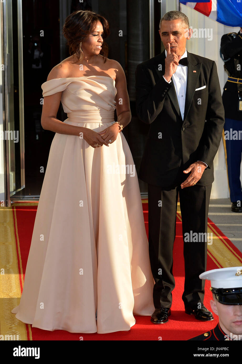 U.S. President Barack Obama gestures a whisper as he and First Lady ...