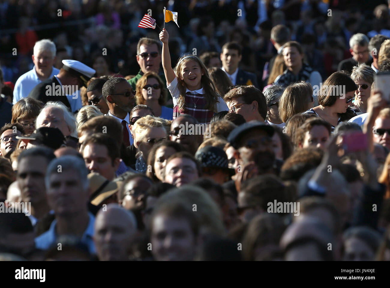 Spectators on the South Lawn of the White House watch as U.S. President ...