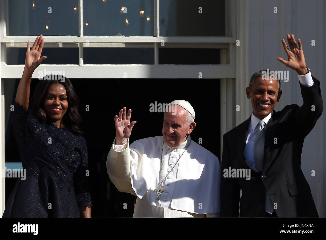U.S. President Barack Obama (R) and first Lady Michelle Obama (L) wave ...