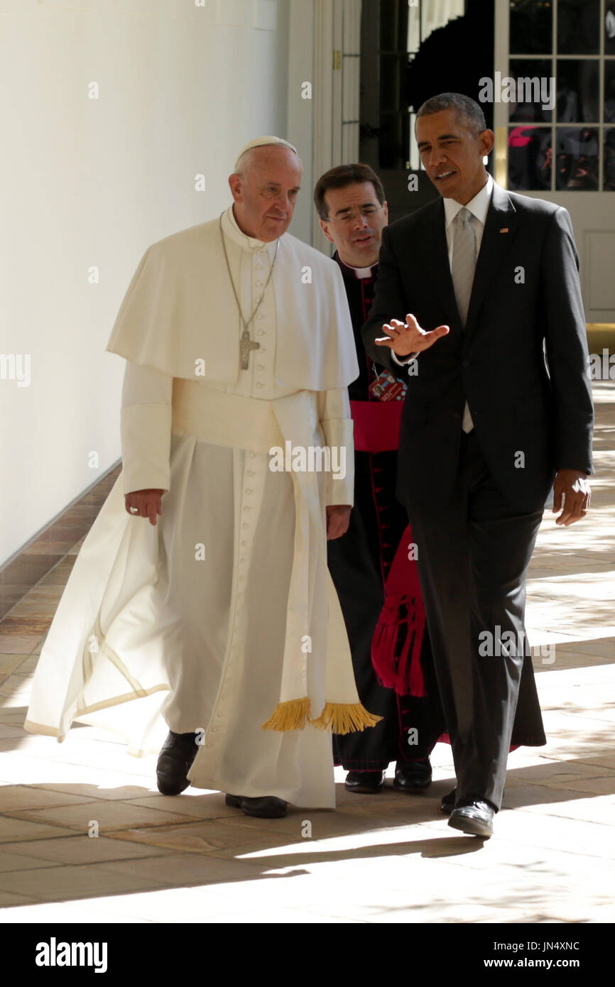 U.S. President Barack Obama (R) escorts Pope Francis (L) down the West ...